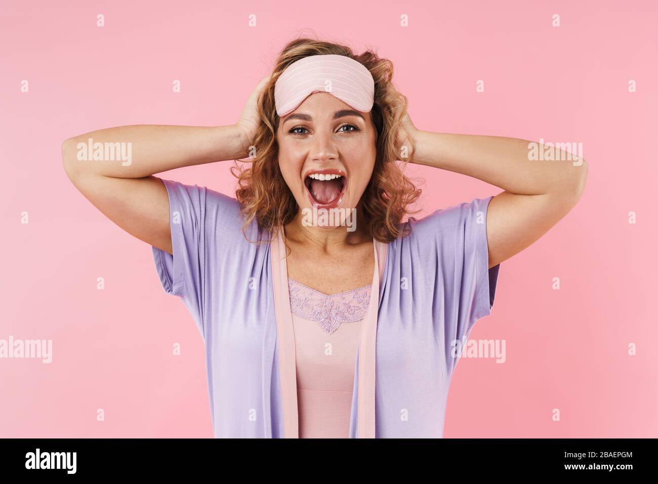 Image of young delighted woman in sleep mask screaming and grabbing her ...