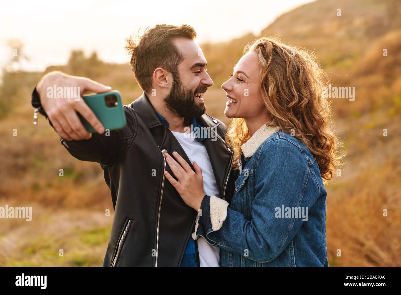 Beautiful Young Happy Stylish Couple Wearing Jackets Standing At The