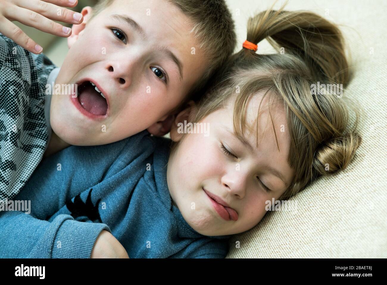 Two children boy and girl fooling around having fun together. Happy ...