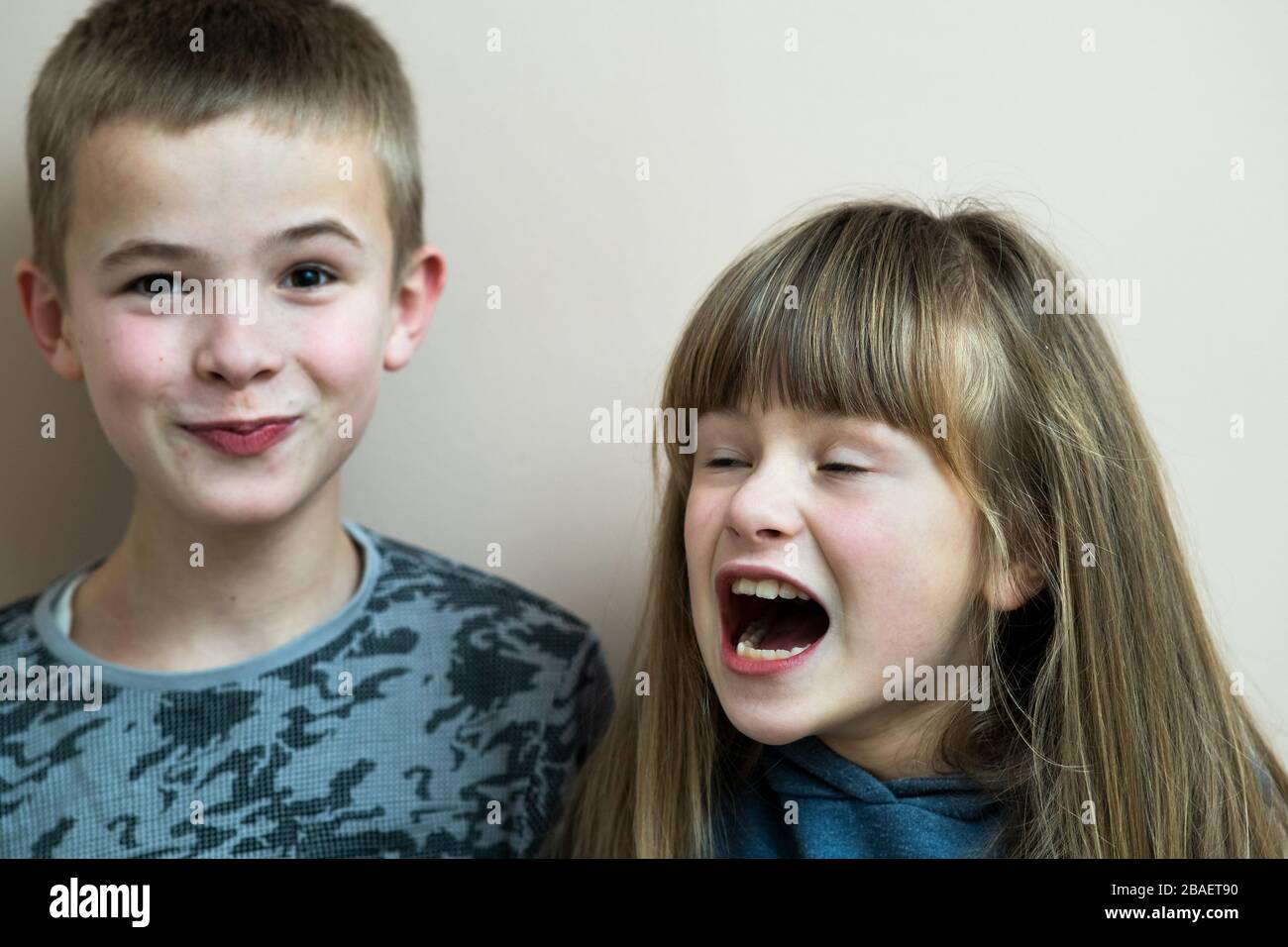 Two children boy and girl fooling around having fun together. Happy ...