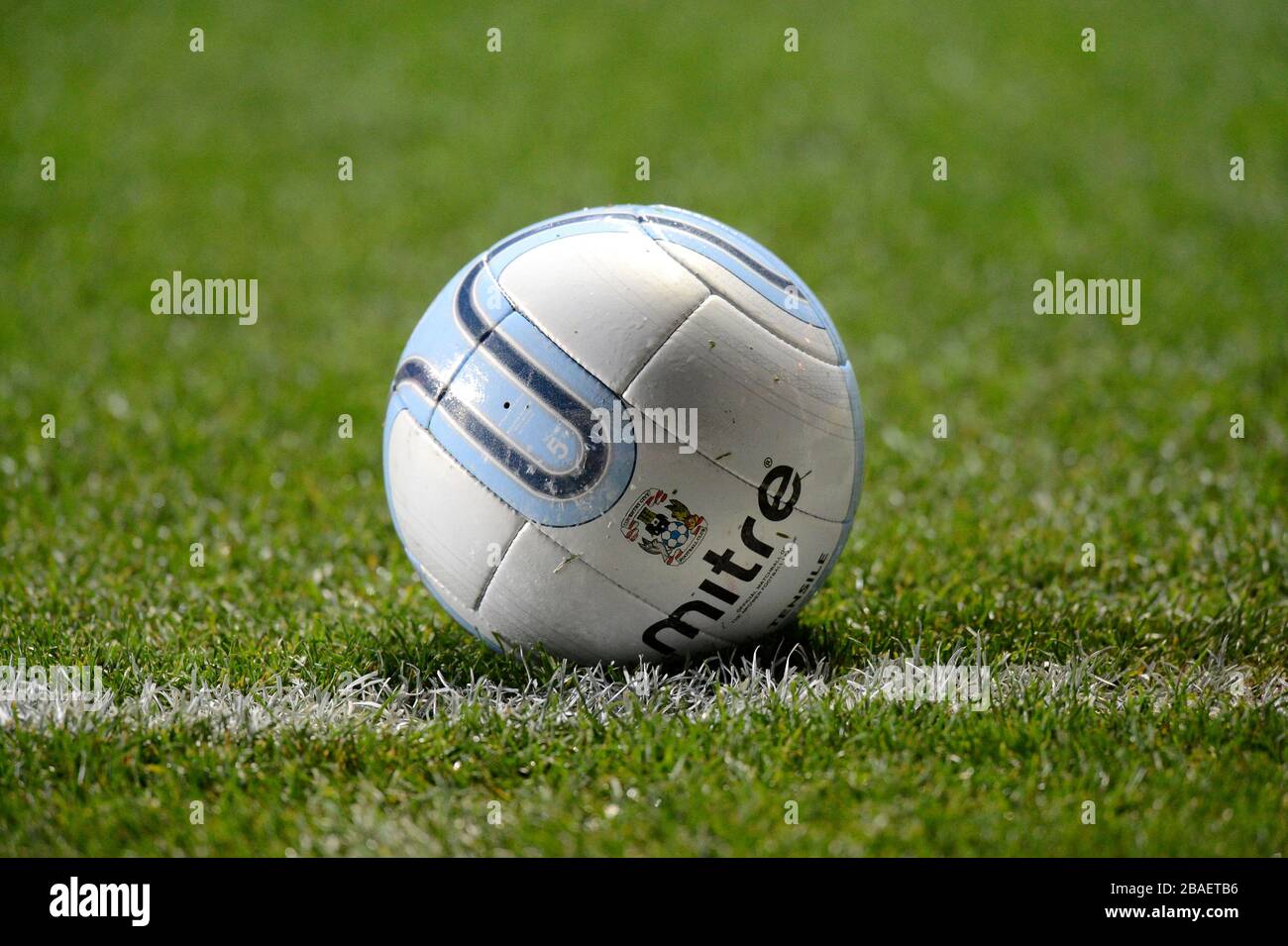 Detail of a Coventry City football on the pitch in front of a touchline ...
