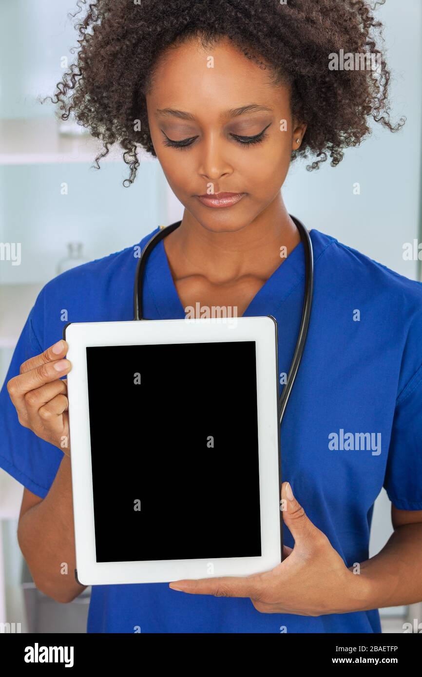 Black African American female medical doctor holding a blank tablet ...