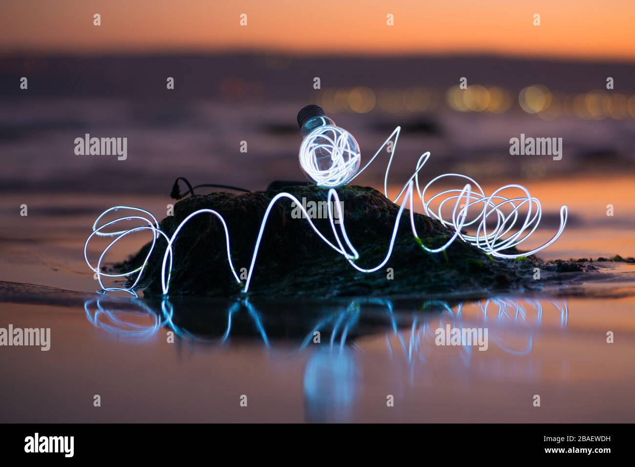 SMART BULB AT THE BEACH. CONCEPT: NEW TECHNOLOGY WITH ENVIRONMENT Stock ...