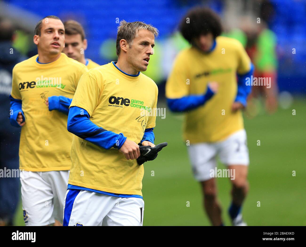 Everton's Leon Osman (left) and Phil Neville (right) warm up before ...