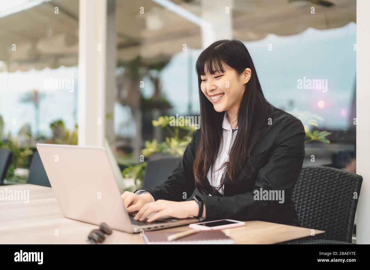 Business Asian woman working on computer outdoor - Happy Chinese girl ...