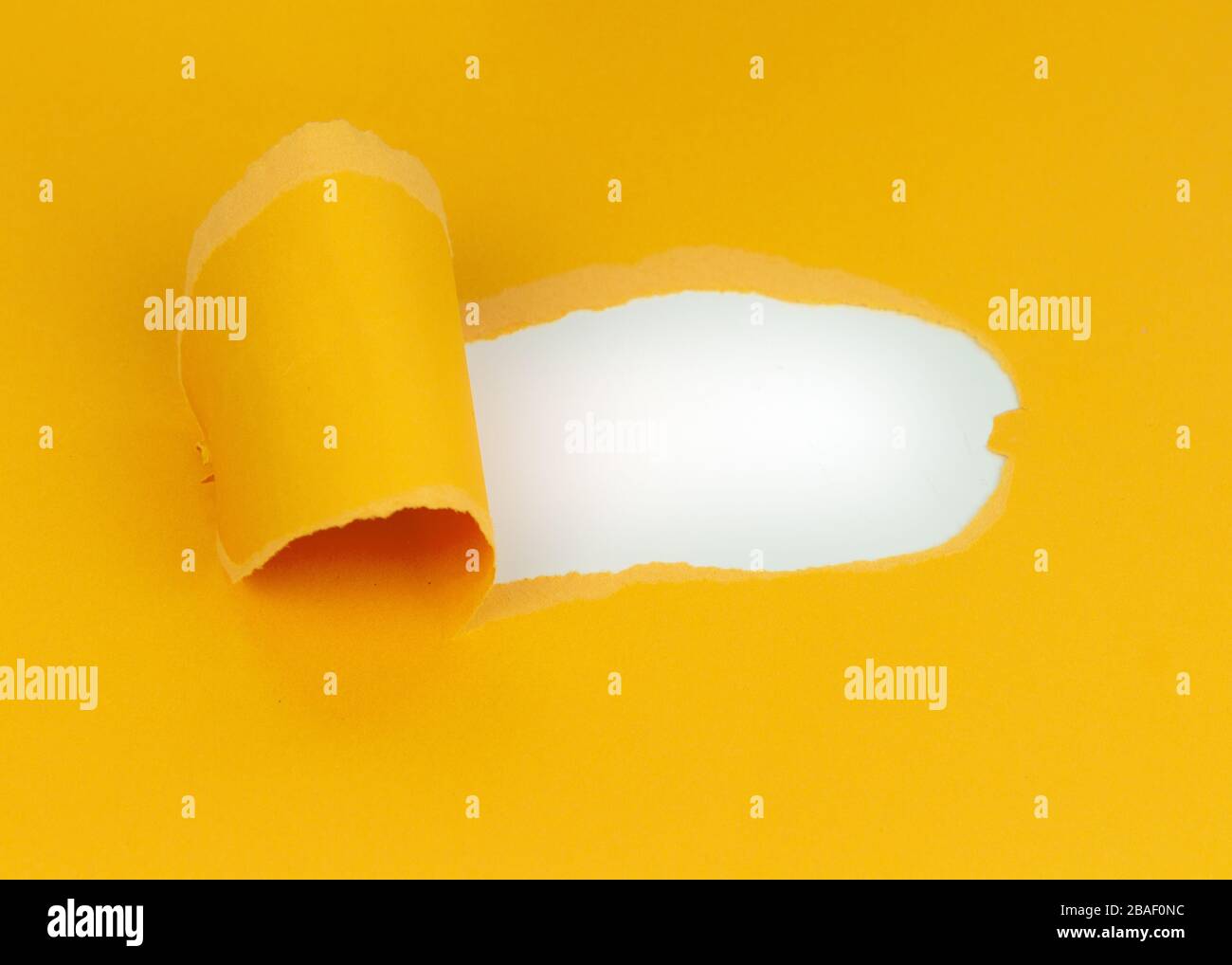 hole in a paper with torn side with a place for text, color surface ...