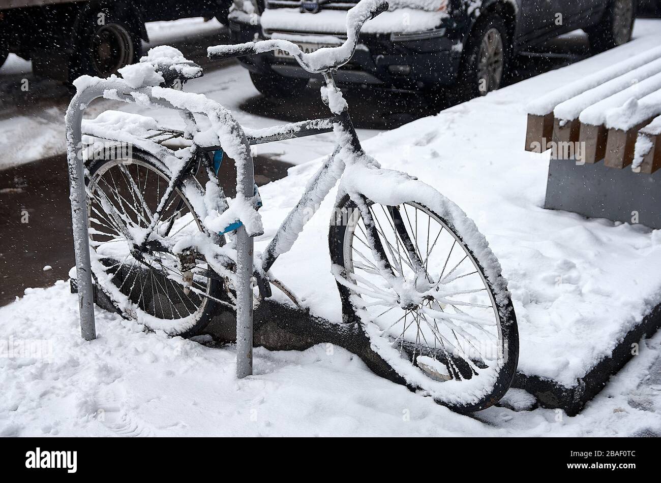 bicycle covered by white snow.white dots this is a large falling snow ...