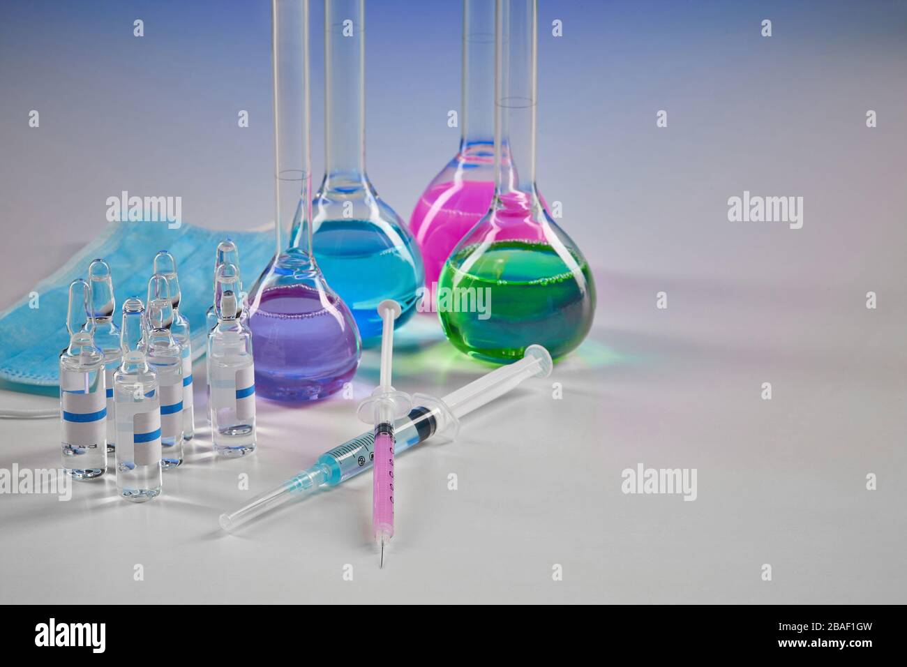 Four medical flasks with colorful chemical reagents. Seven mockup ...