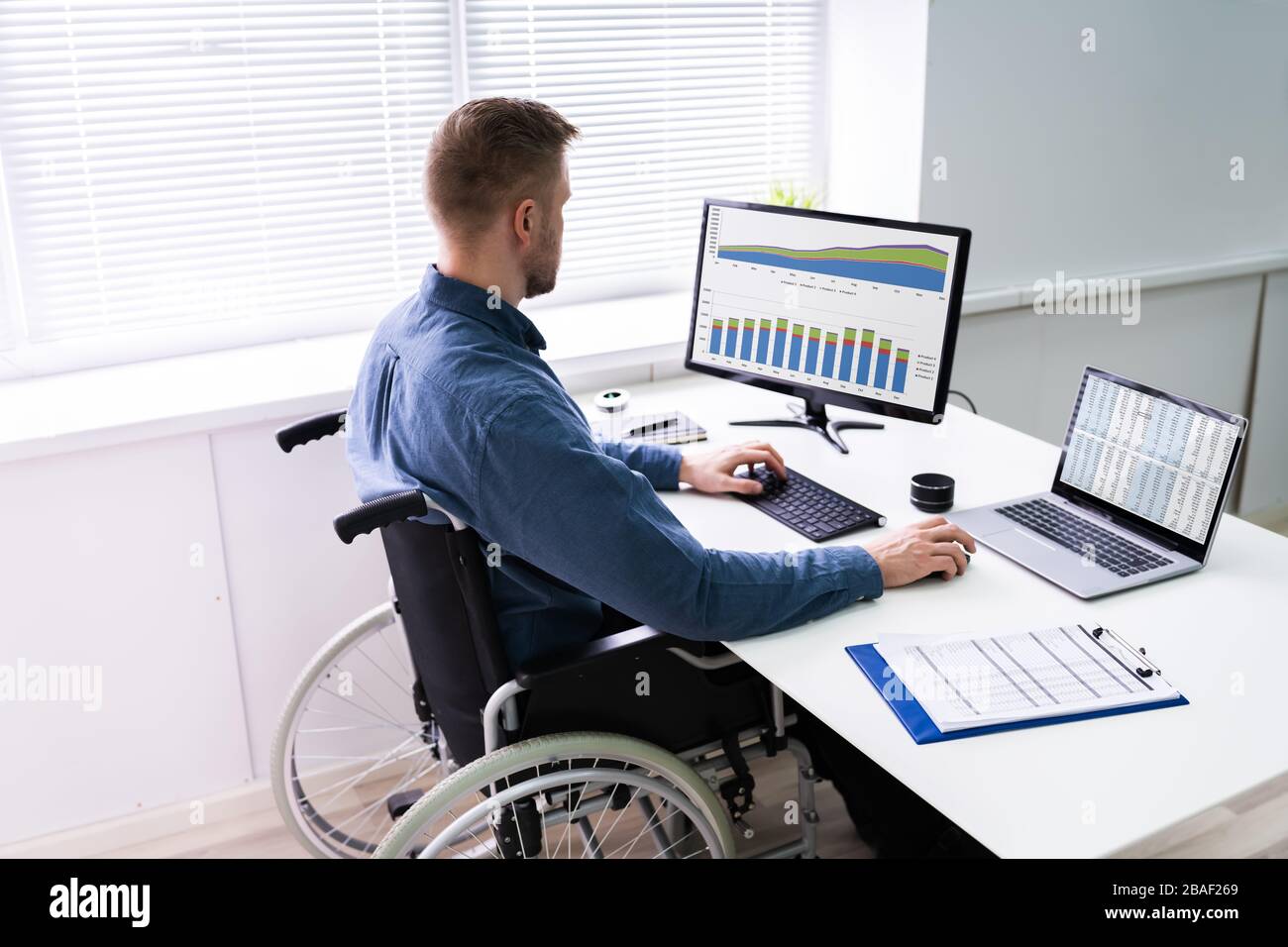 Handicapped Businessman Sitting On Wheelchair And Using Computer In ...