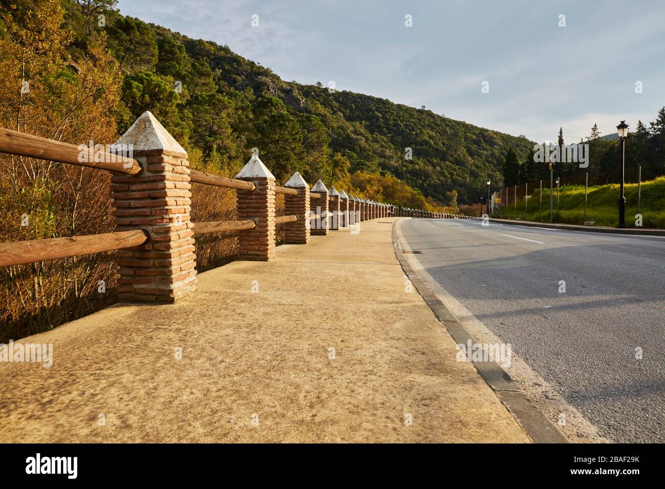 beautiful mountain road with a curve to the right going up the mountain ...