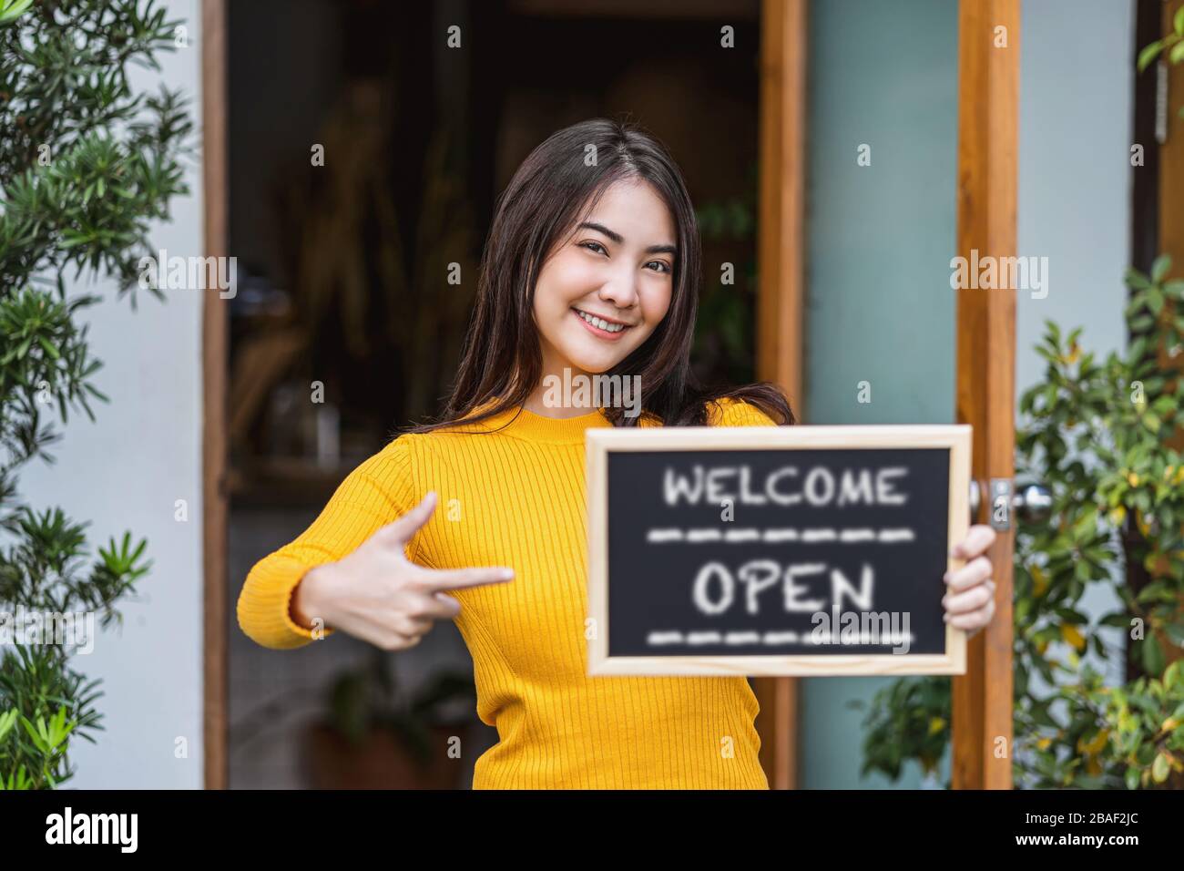 Asian Small business owner hands holding and showing the chalkboard ...