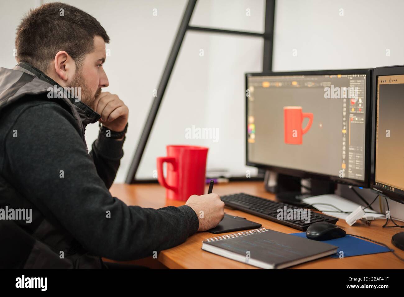 Graphic designer and 3d program animator work at computer in the office ...