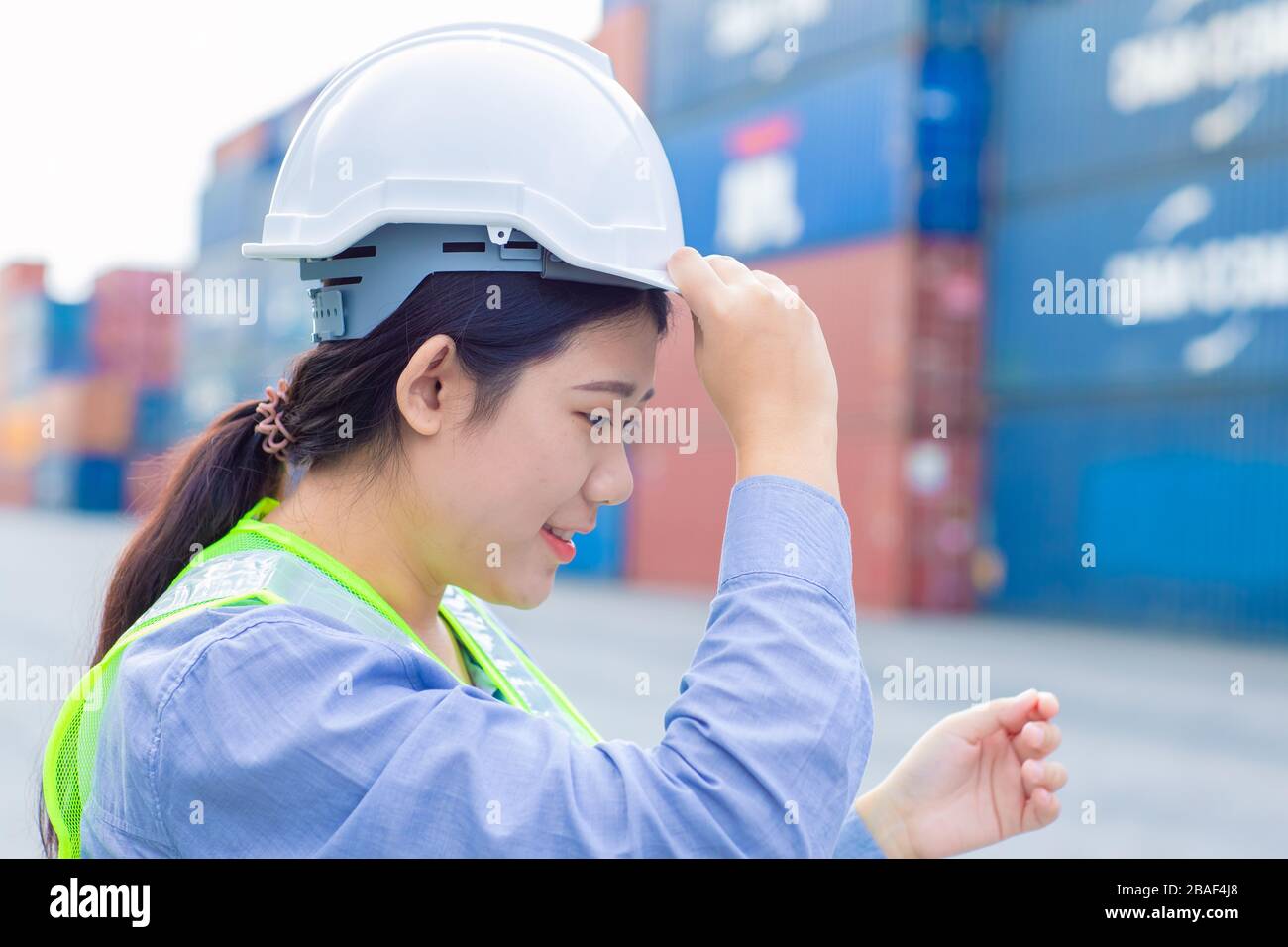 Asian girl teen worker in shipping cargo port work and manage import ...