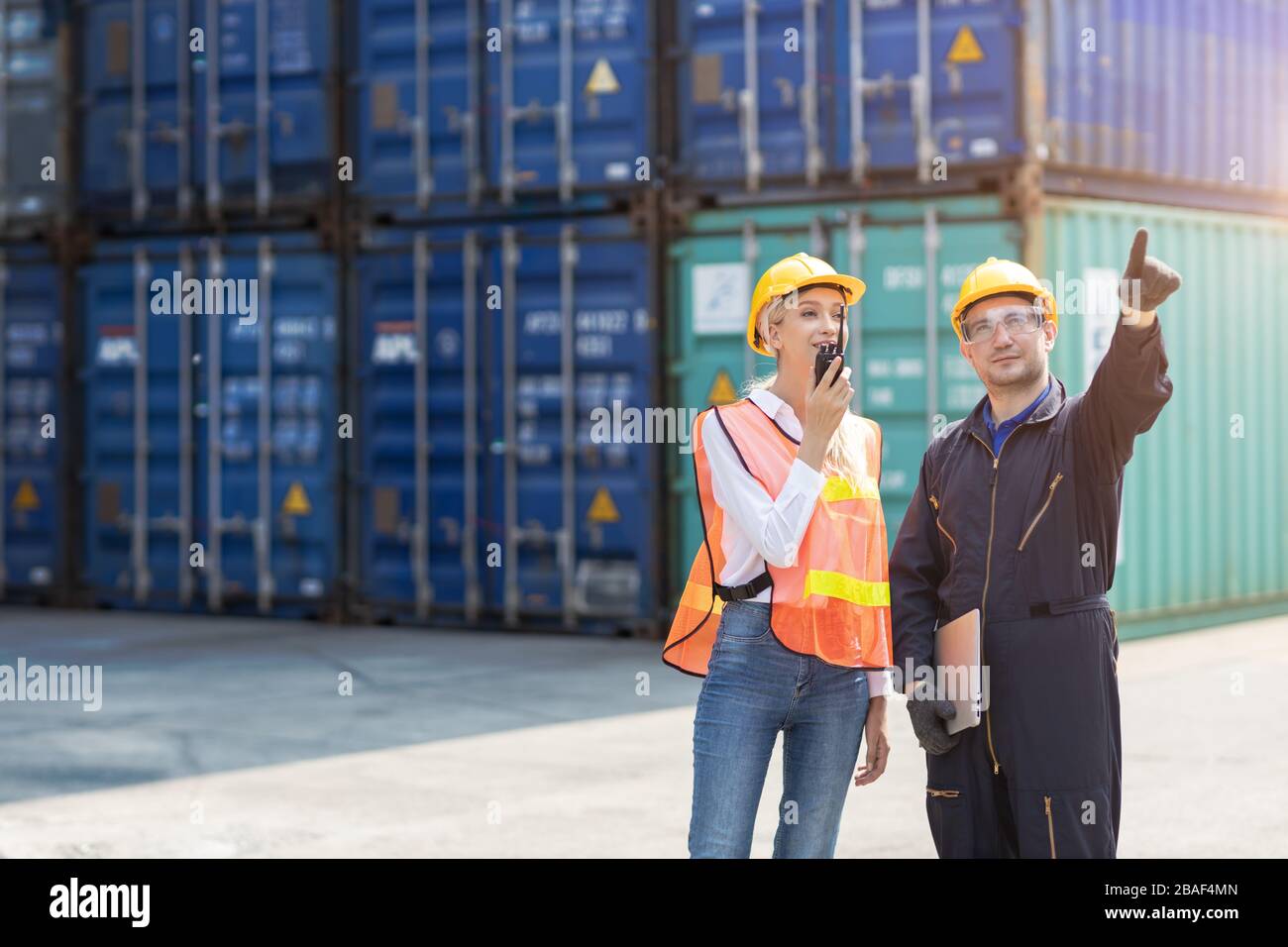 logistic worker man and woman working team with radio control loading ...