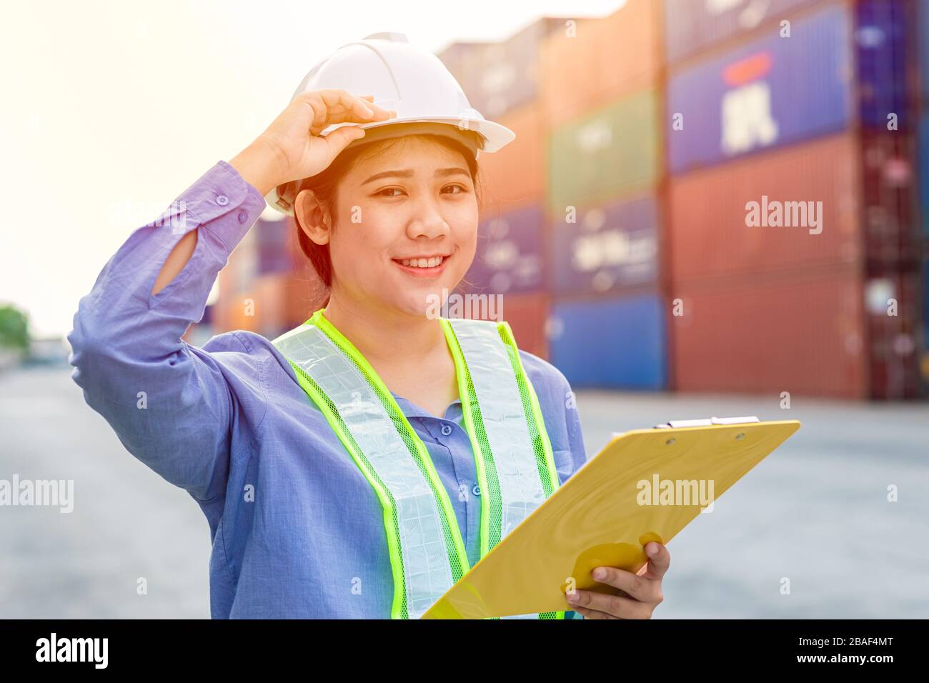 Portrait of Asian girl teen worker working in shipping cargo port ...