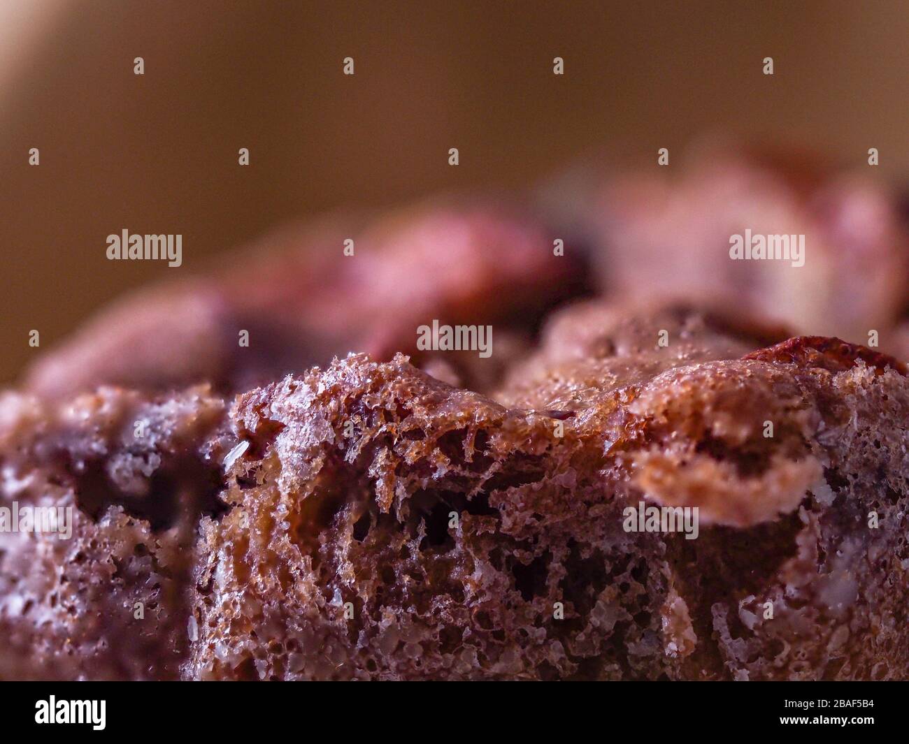 A photo of an whole flour apple pie in allu foil, on a dark rustic ...