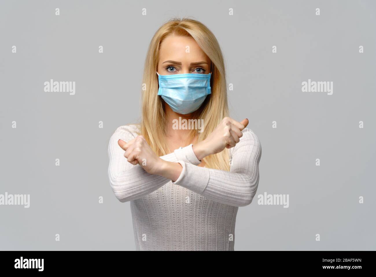 Studio portrait of young woman wearing a face protective mask isolated ...