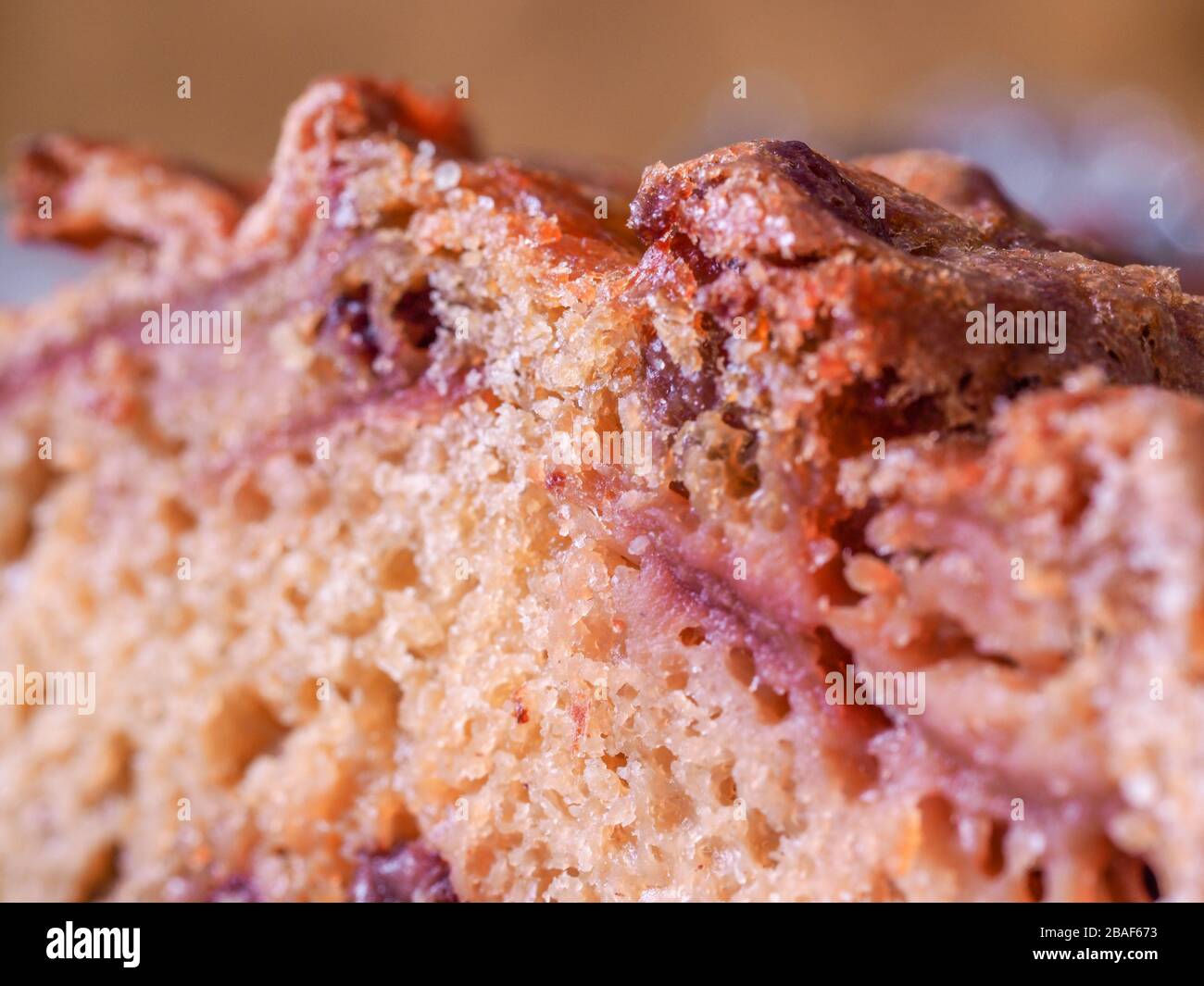A photo of an whole flour apple pie in allu foil, on a dark rustic ...