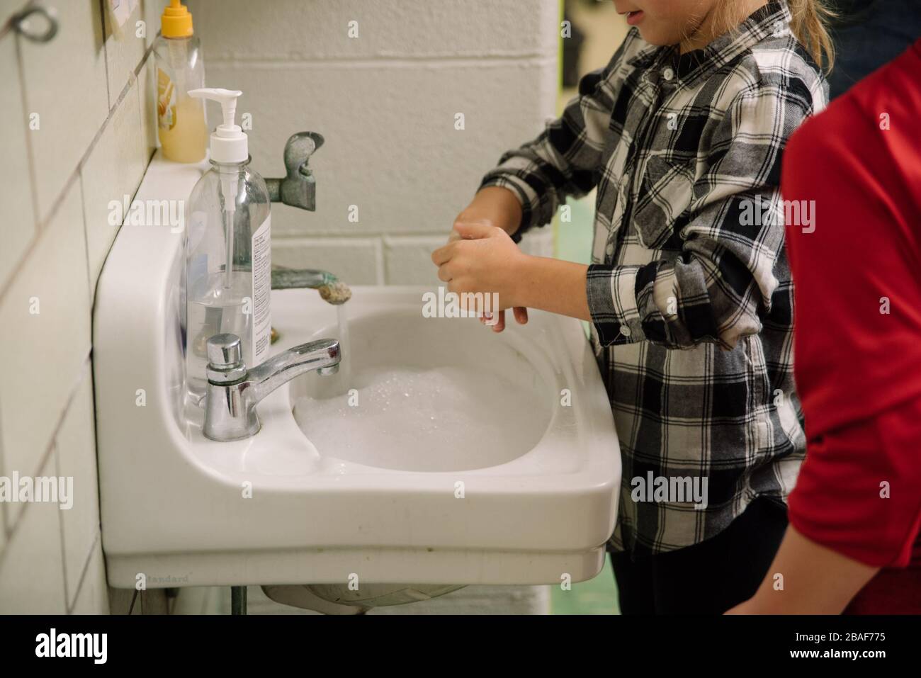 child washing hands in school sink Stock Photo - Alamy