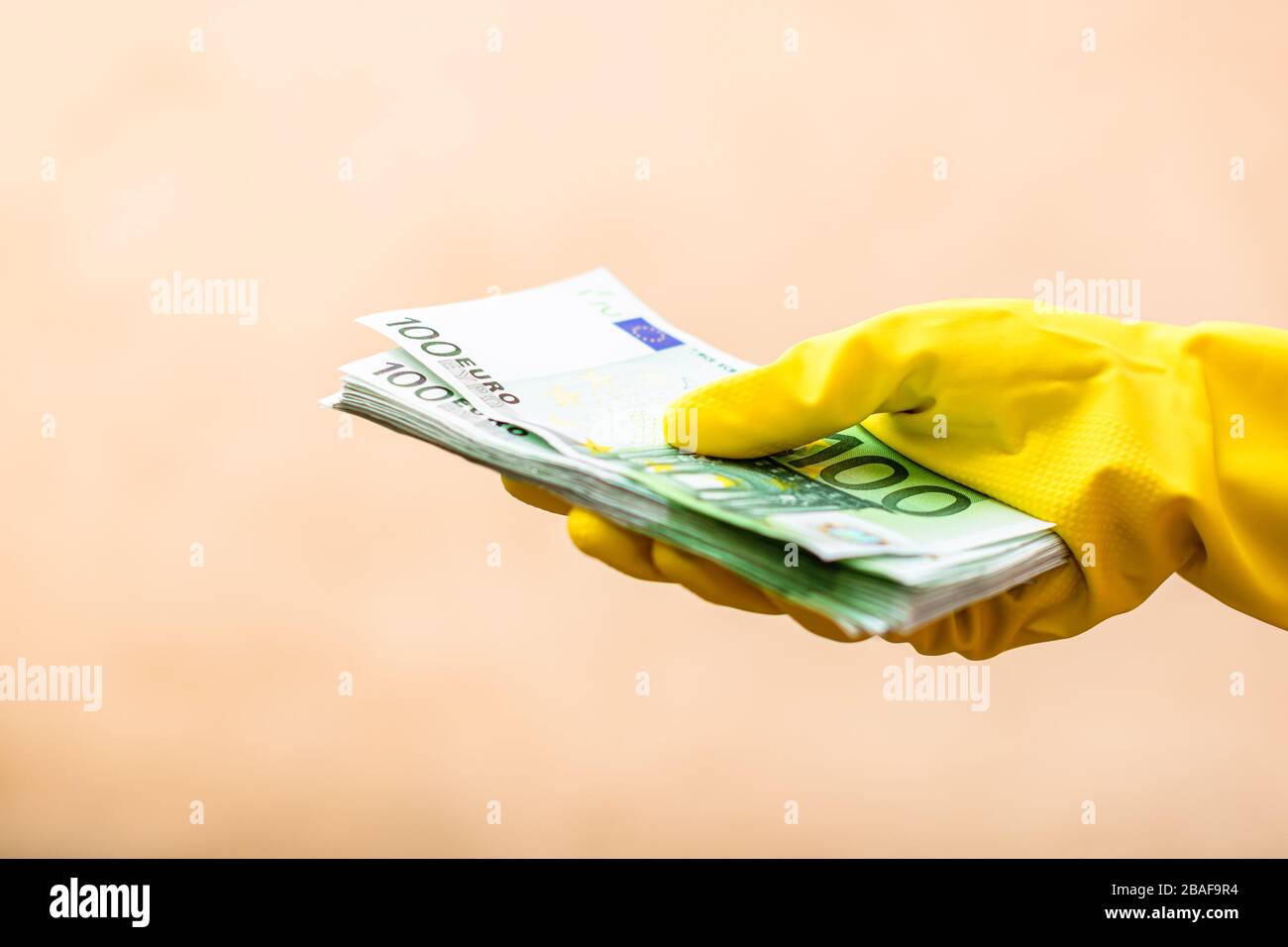 World money concept, hand with gloves receiving, giving or holding 100 ...