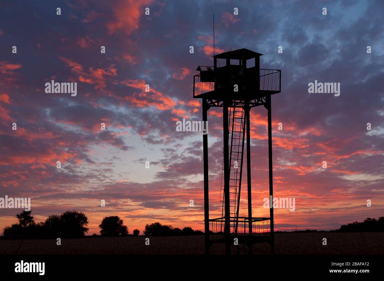 watch tower on sunset sky background Stock Photo - Alamy