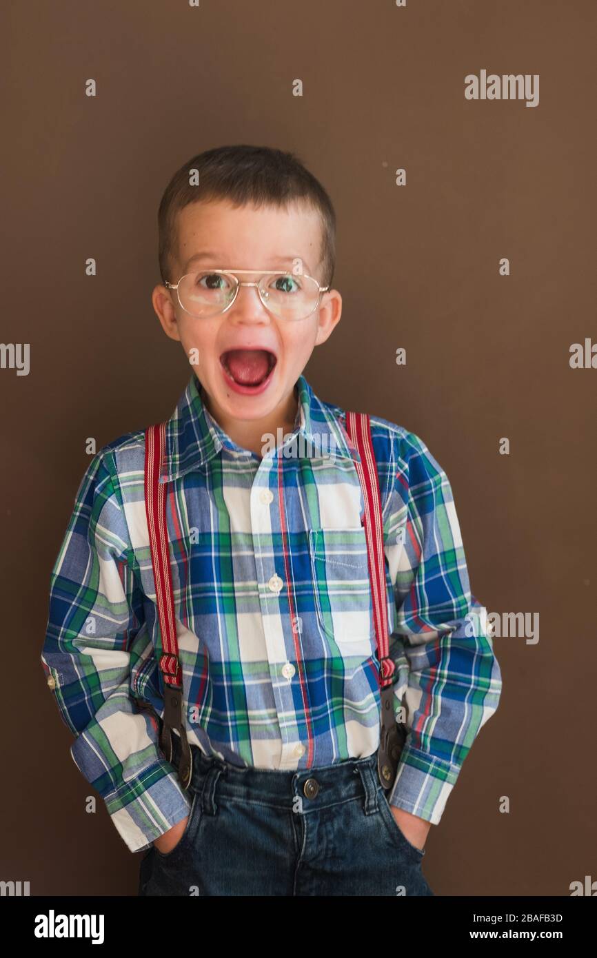 Smiling kid looking at camera in front of blackboard Stock Photo - Alamy