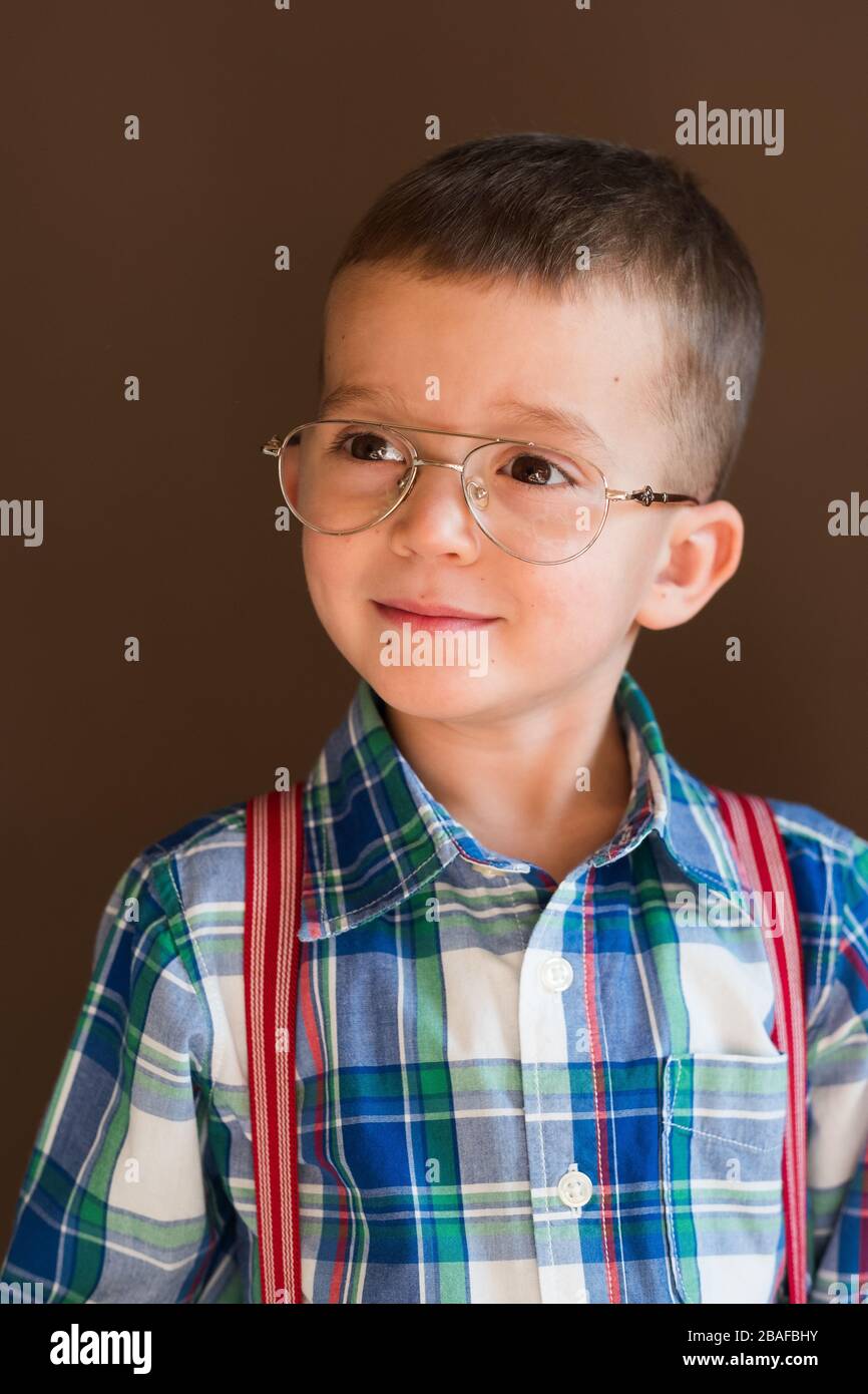 Smiling kid looking at camera in front of blackboard Stock Photo - Alamy