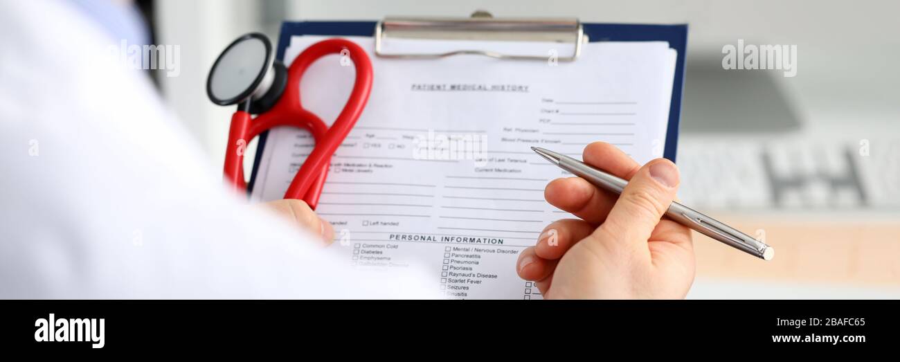 Male medicine doctor hand holding silver pen writing Stock Photo - Alamy