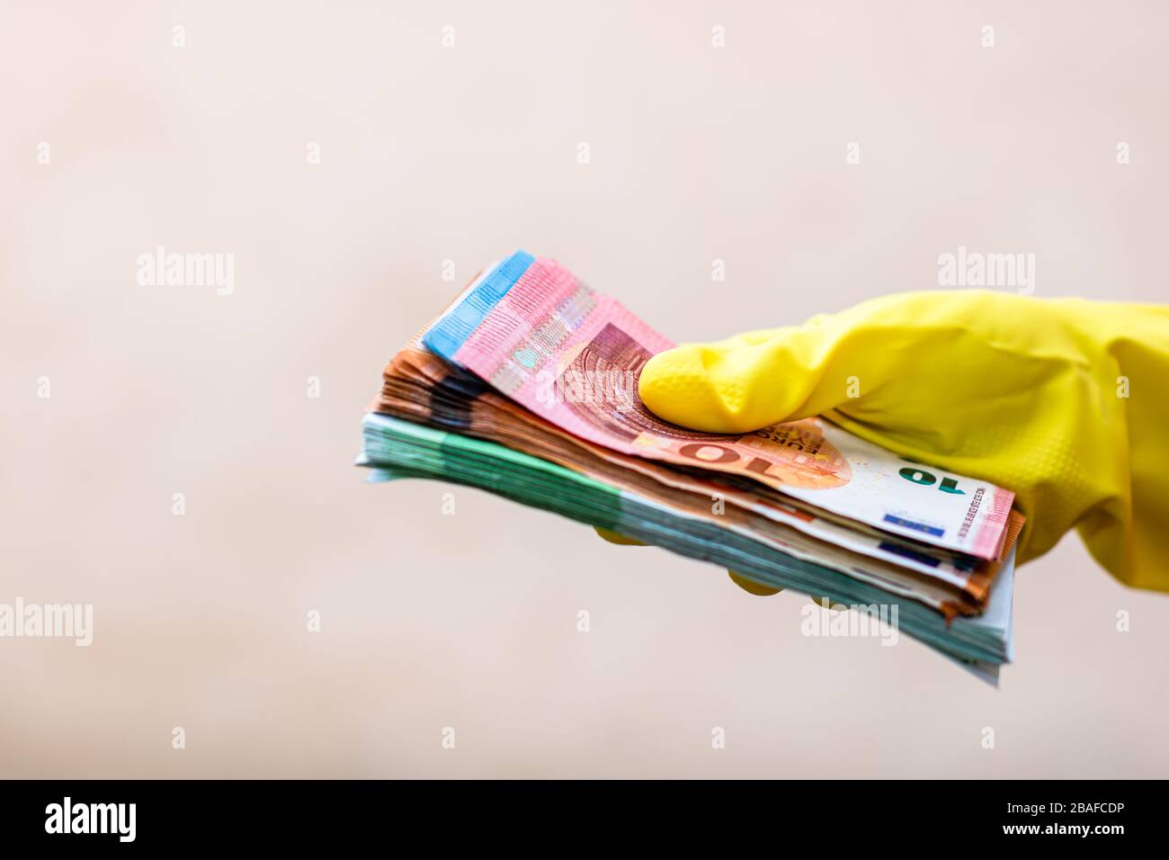 World money concept, hand with gloves receiving, giving or holding EURO ...