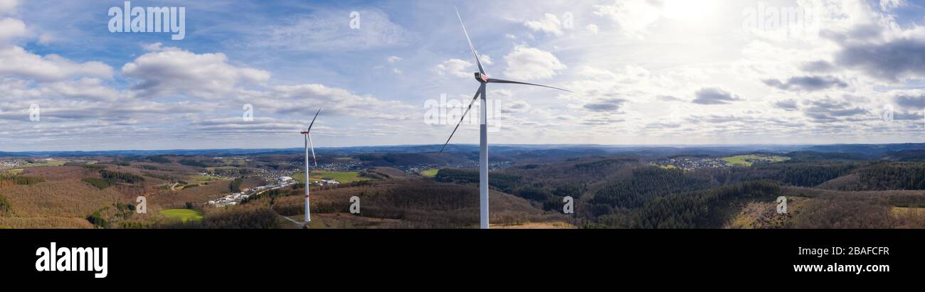 two wind wheels in an bright cloudscape high definition panorama Stock ...