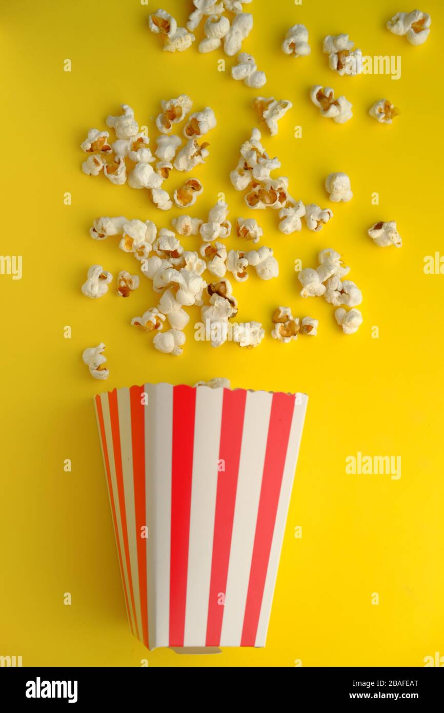 top view of popcorn spilling on yellow background Stock Photo - Alamy