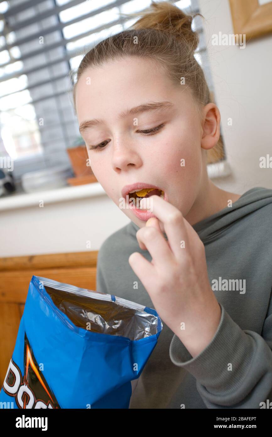 Young girl eating Dorito chips Stock Photo - Alamy