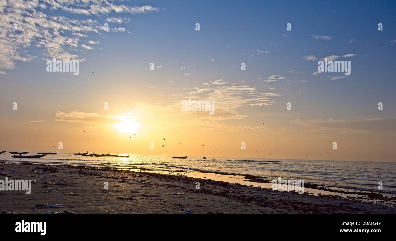 Sunset over the ocean, beach and fishing boats, Tanji, Gambia Stock ...