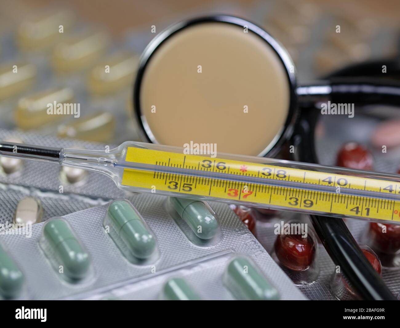 Medical thermometer, stethoscope and medication in a close-up Stock ...