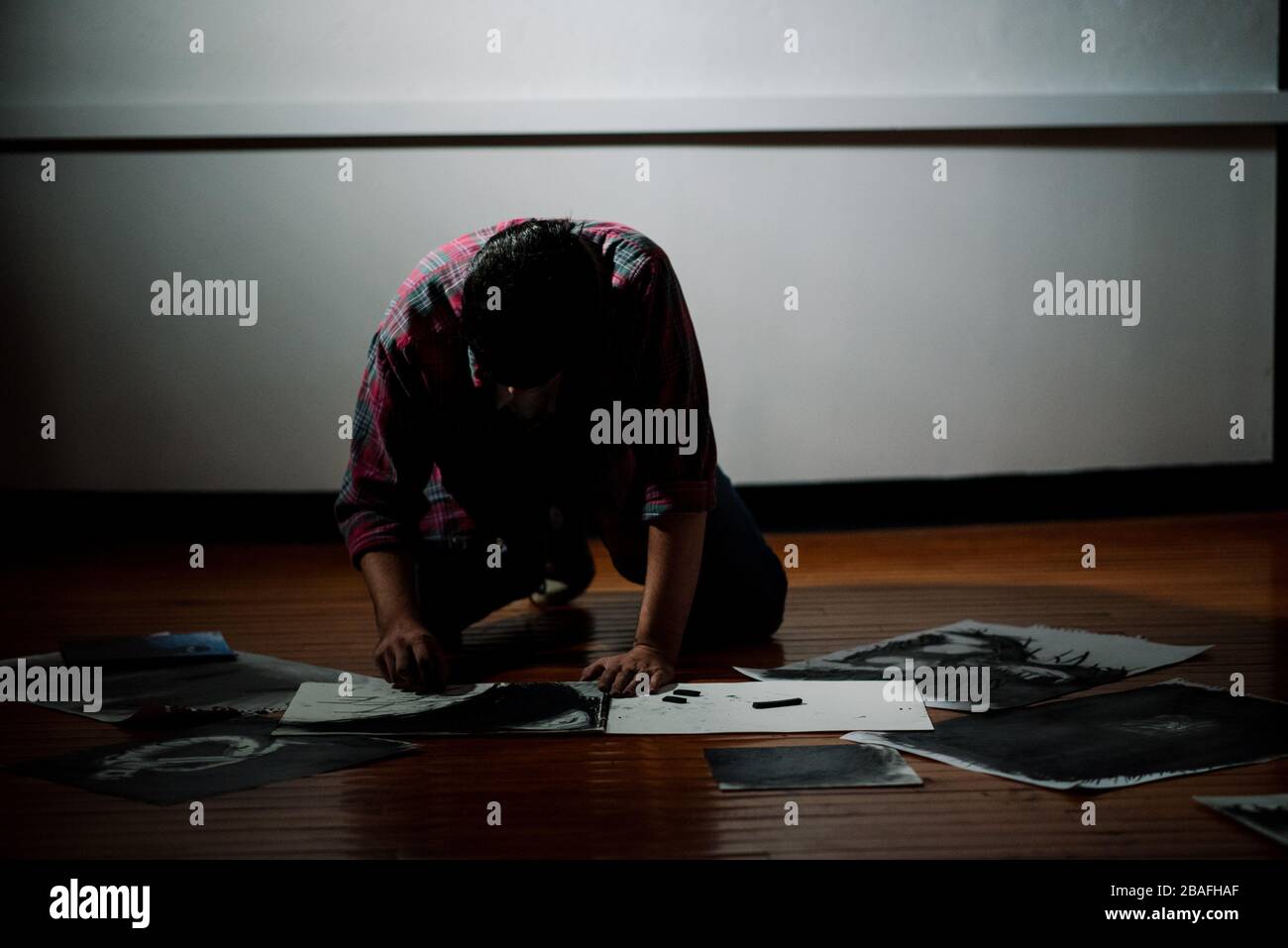 shadowy disturbed artist drawing on floor Stock Photo - Alamy