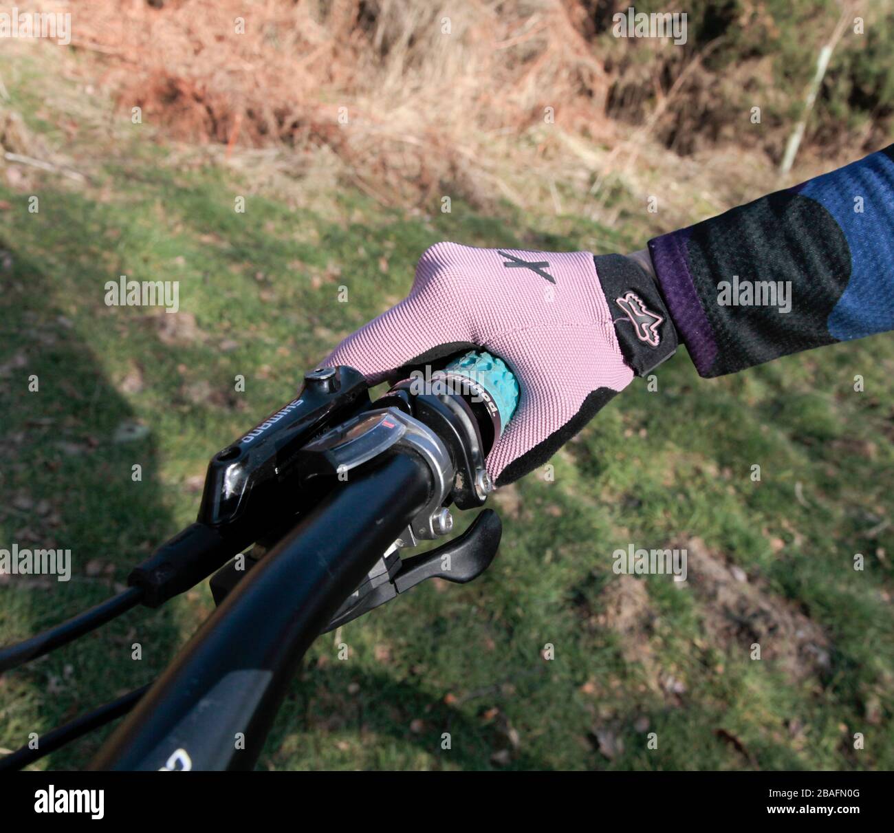 Young woman's hand on mountain bike handlebar grip Stock Photo - Alamy
