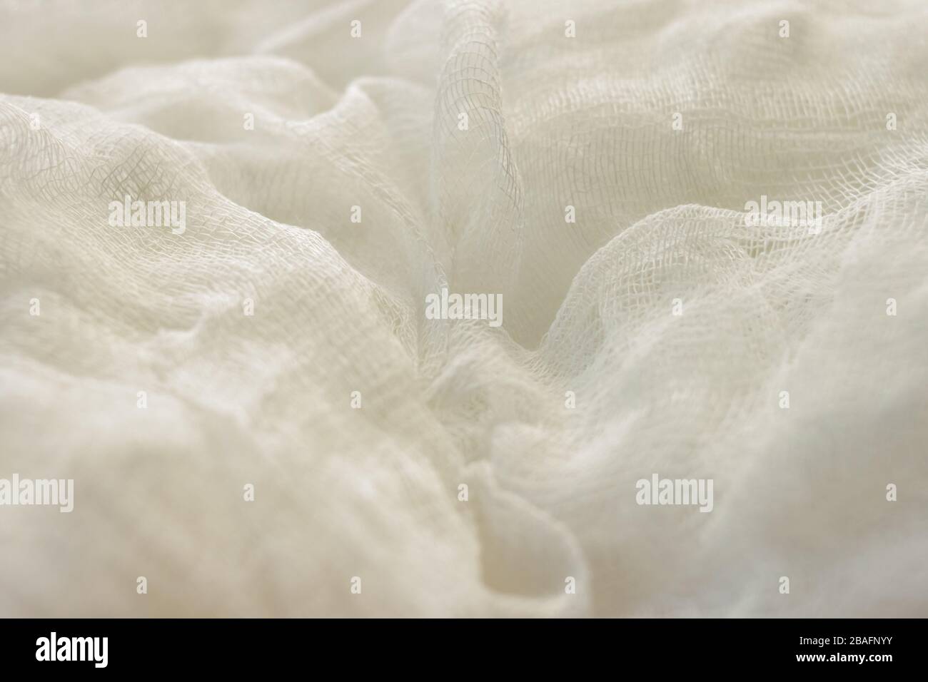 white color woven cotton gauze fabric background texture. close up top ...