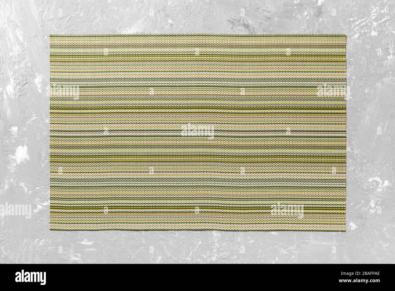 Top view of textile green mat for dinner on cement background with copy ...