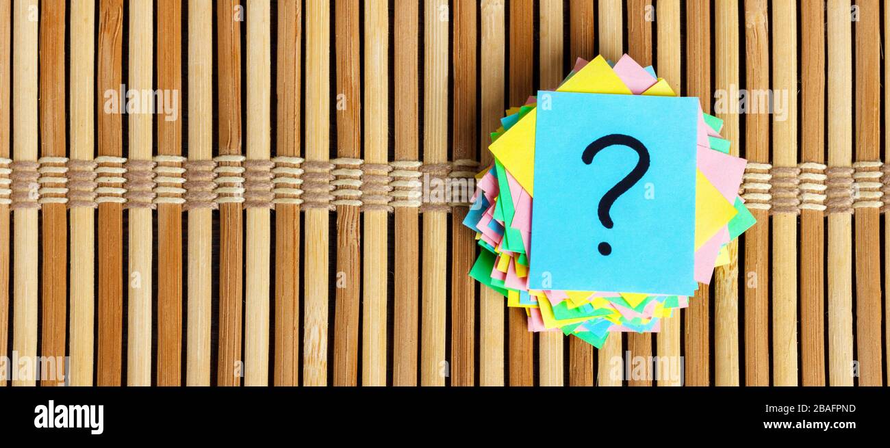 Question mark paper heap on table concept for confusion Stock Photo - Alamy
