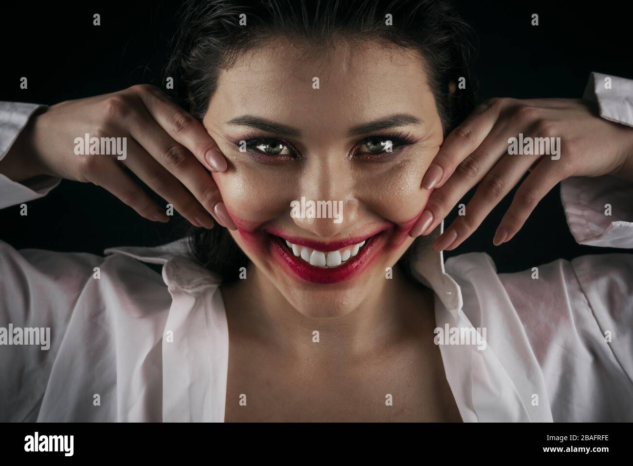 Crazy-looking woman smearing lipstick Stock Photo - Alamy