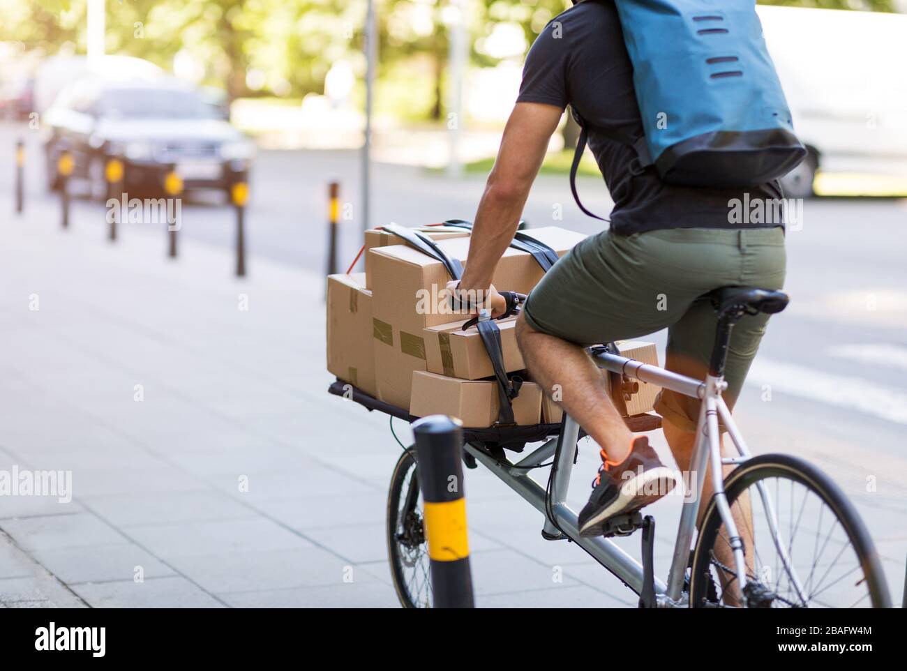 Bicycle messenger making a delivery on a cargo bike Stock Photo - Alamy