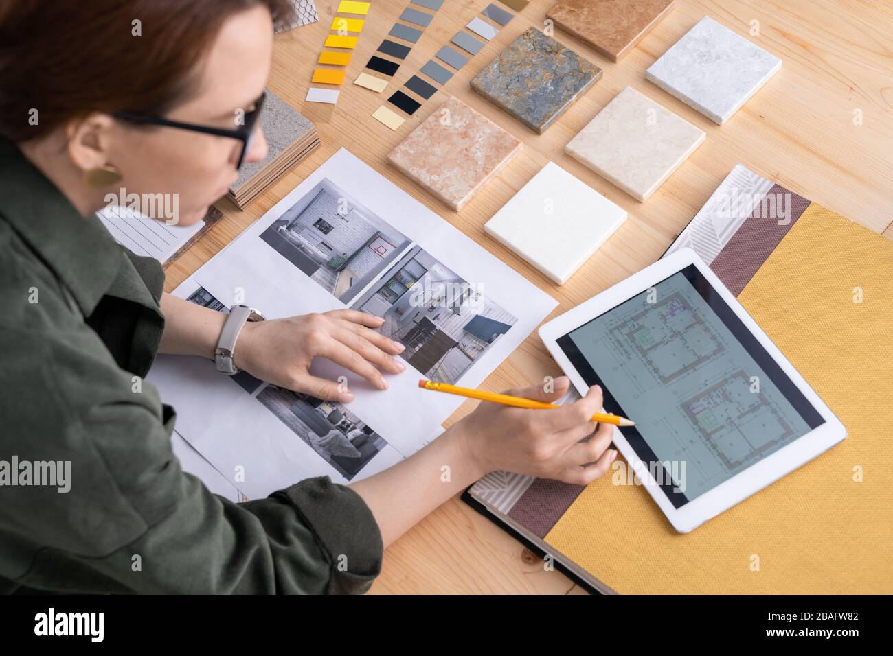 Businesswoman bending over in office hi-res stock photography and ...