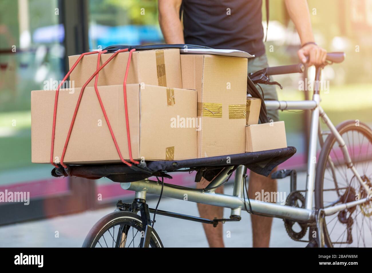 Bicycle messenger making a delivery on a cargo bike Stock Photo - Alamy