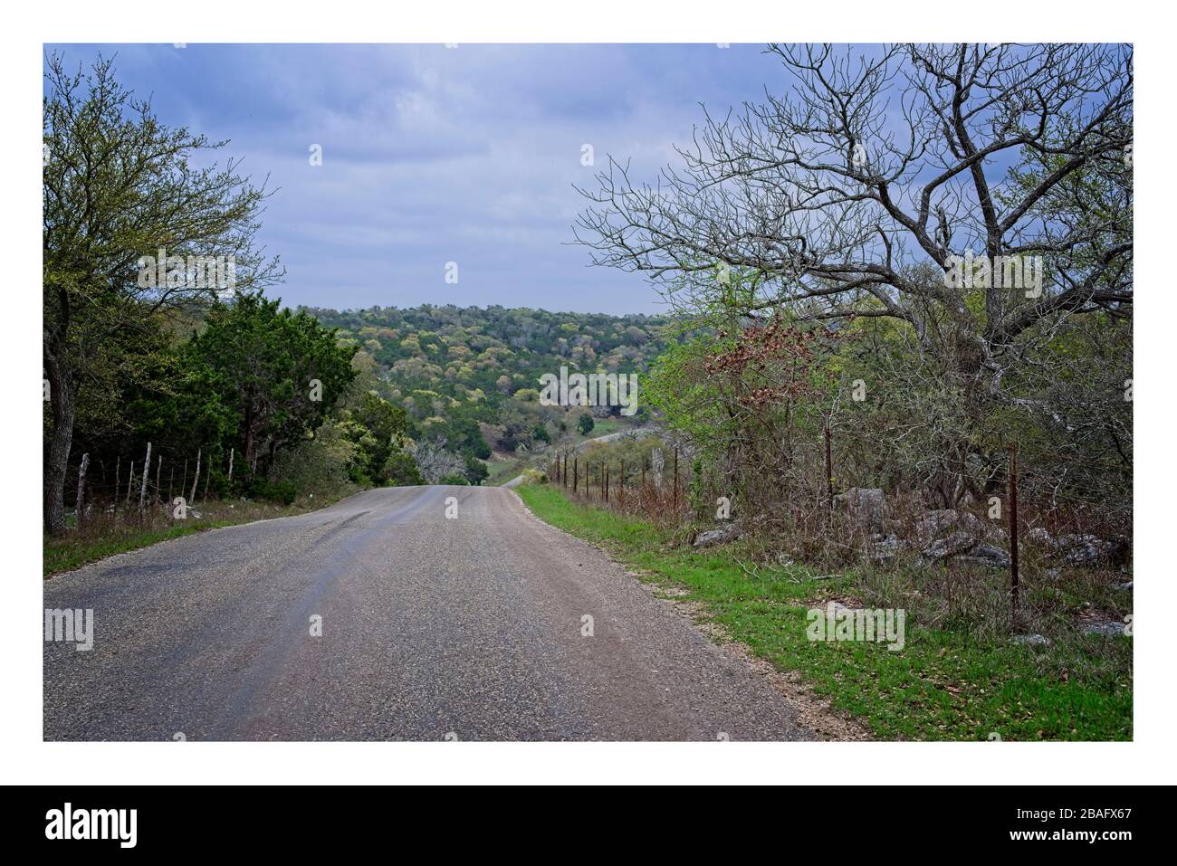 Texas Hill Country rural road with hills and a cloudy sky Stock Photo ...
