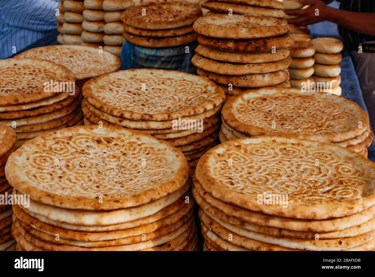 Traditional Uyghur flat bread on a market stall in Kashgar, China Stock ...