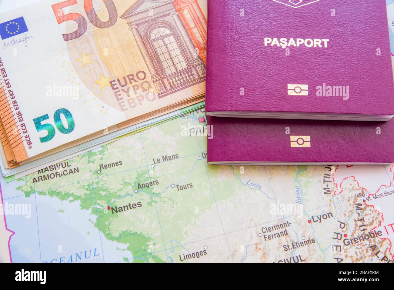 Euro banknotes and biometric passports over map Stock Photo - Alamy