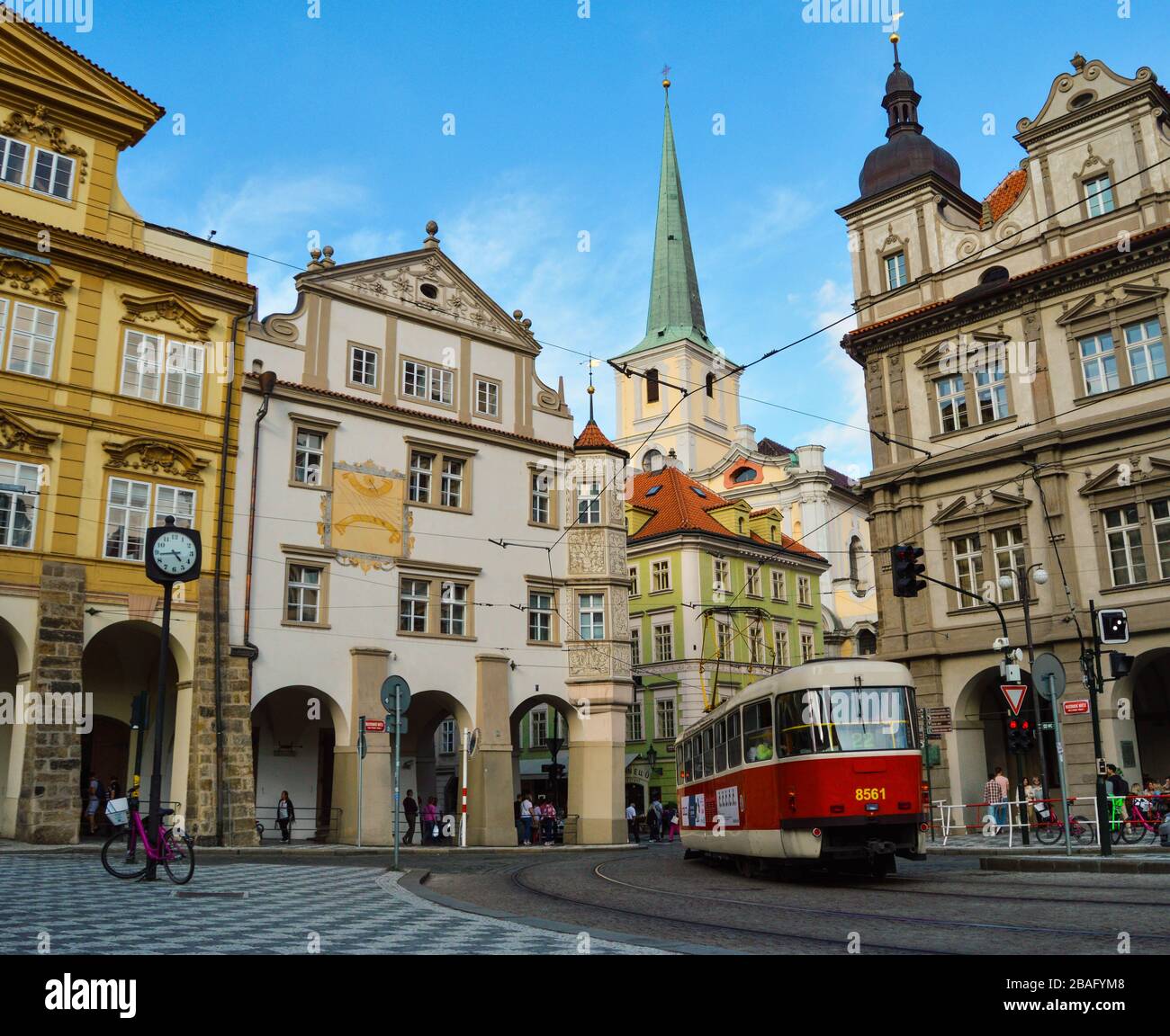 Red old tram in Lesser Town square (Malostranske Namesti) and church of ...