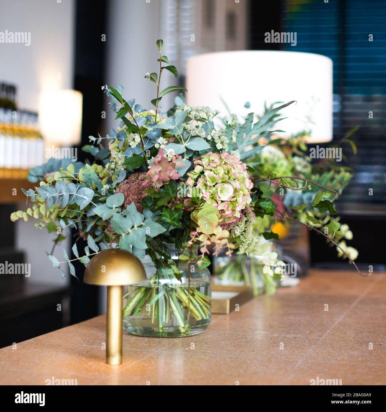 Floral table setting on the bar in a stylish modern Scandi restaurant ...