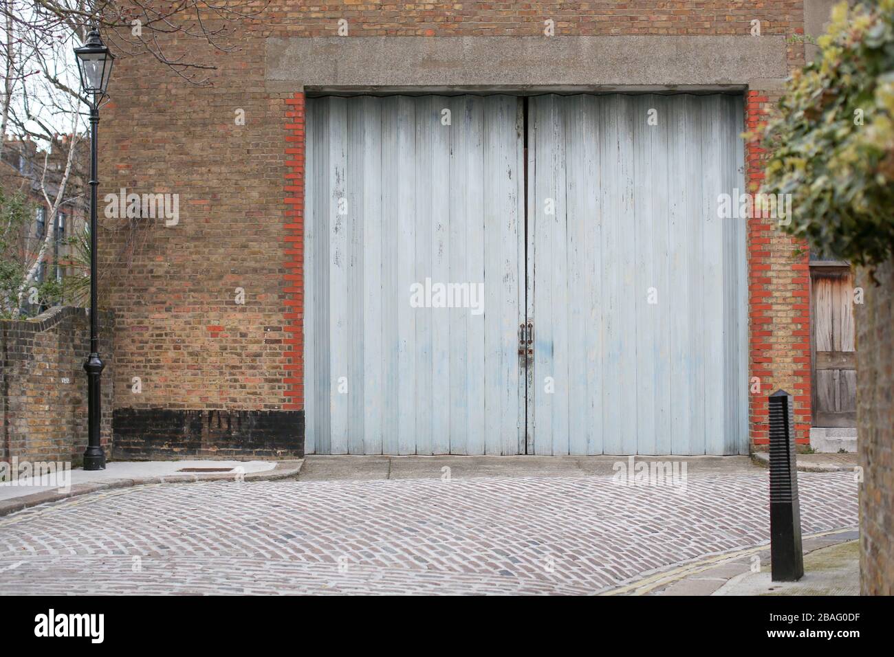 Large / tall grey blue concertina doors to a factory or warehouse in a ...
