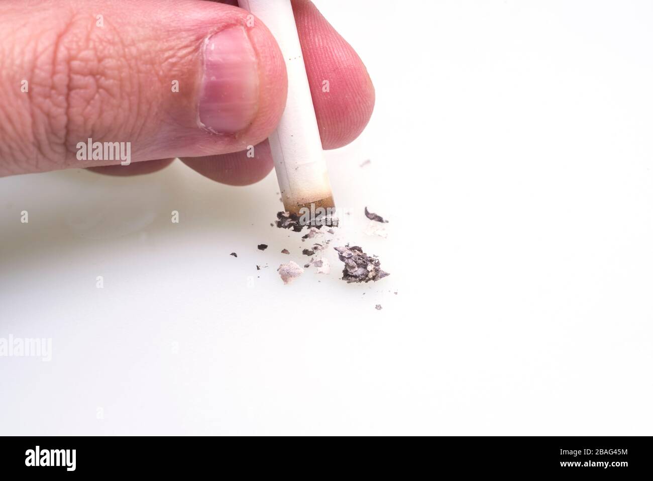 Man hand extinguish a cigarette on white Stock Photo - Alamy